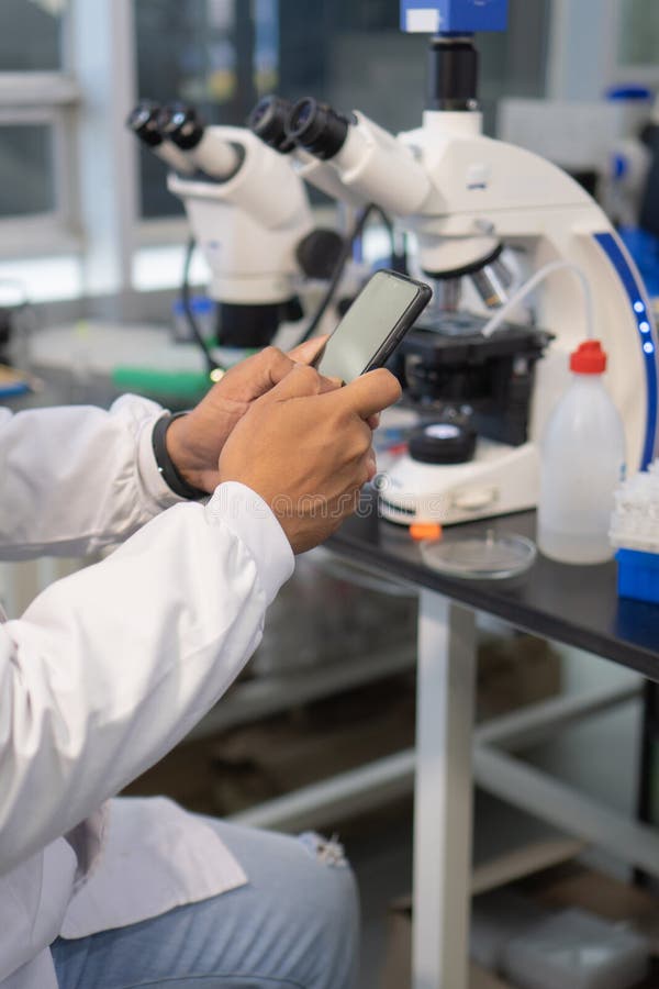 Close-up of a Scientist Using a Cell Phone in the Laboratory Stock ...