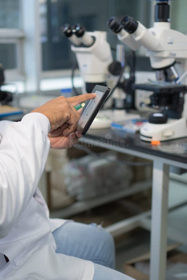 Close-up of a Scientist Using a Handheld Tablet in the Laboratory Stock ...