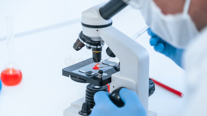 Close Up. Scientist Using a Microscope To Study Blood Stock Image ...