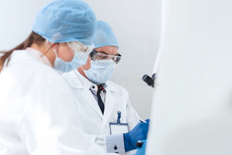 Close Up. Scientists in Protective Masks Work in the Laboratory Stock ...