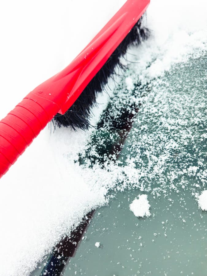 Close-up of Scraper Brush Being Used To Remove Snow from Car Windshield ...