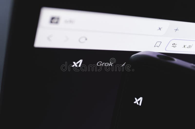 Close-up of a Screen Displaying the Grok Logo and the X.ai Website in a ...
