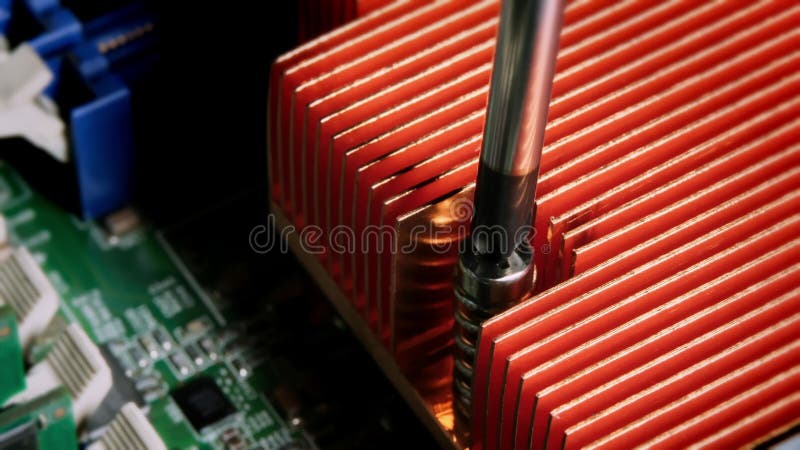 Close-up of a Screwdriver Securing a Red Heat Sink Onto a Computer ...