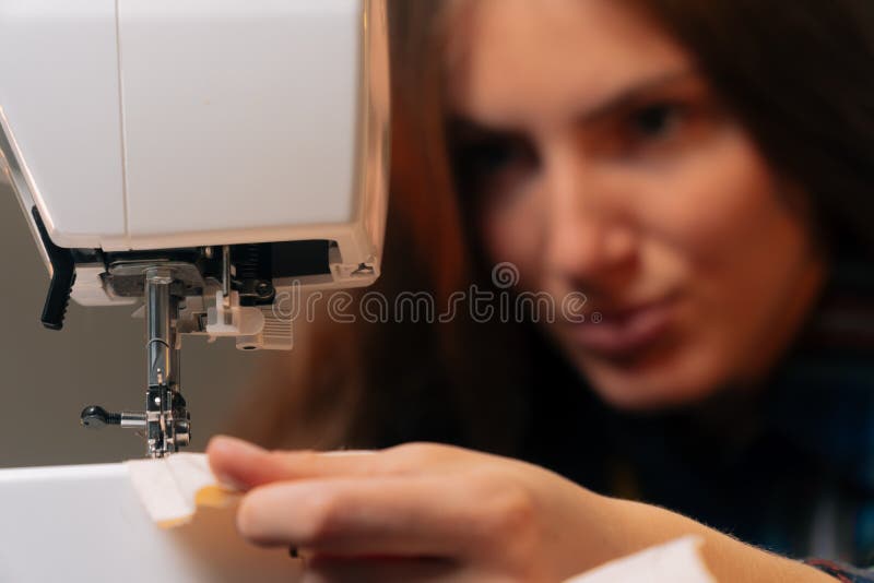 A Close-up of the Seamstress Blows a Thread into the Needle of the ...