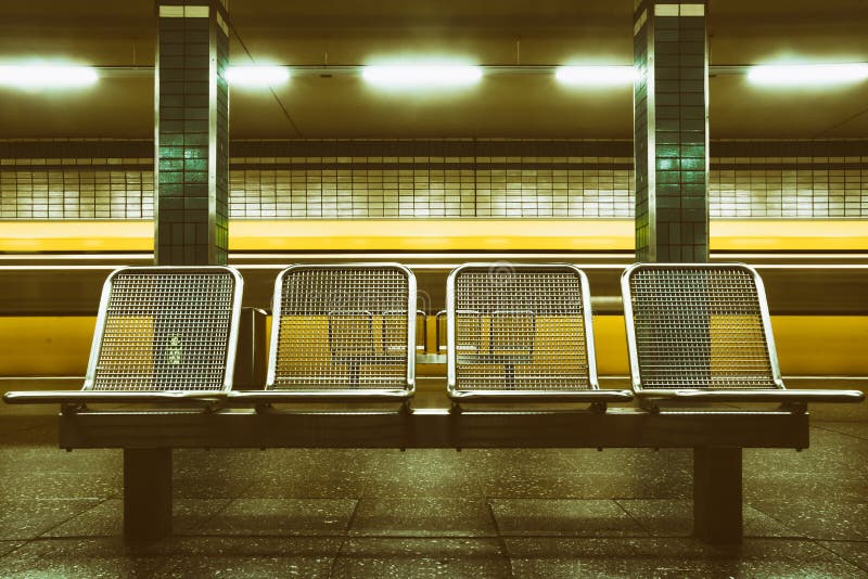 Close-up of Seats at the Metro Station. in the Background, a Pas ...