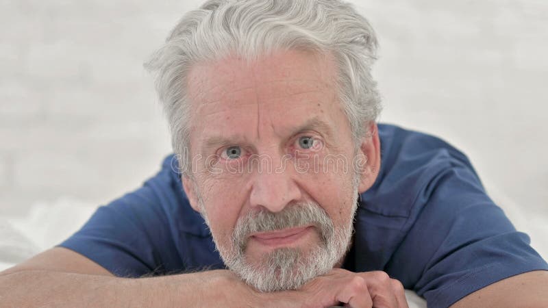 Sad Old Man Sitting in Bed and Looking at Pills, Medication and ...