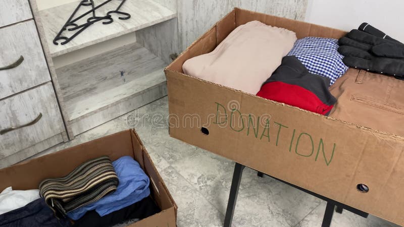 Close-up a Several Cardboard Boxes with Things, with an Empty Clothes ...