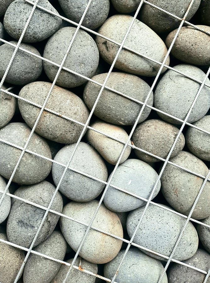 A Close-up of Several Smooth, Rounded Stones Arranged within a Grid ...