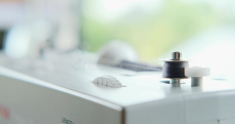 A Close-up of a Sewing Machine with a Spool Installed on Which Threads ...