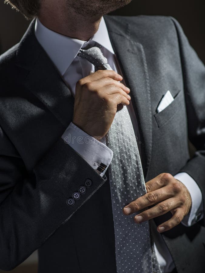 Close-up of Sharp Dressed Businessman Adjusting His Necktie. Stock ...