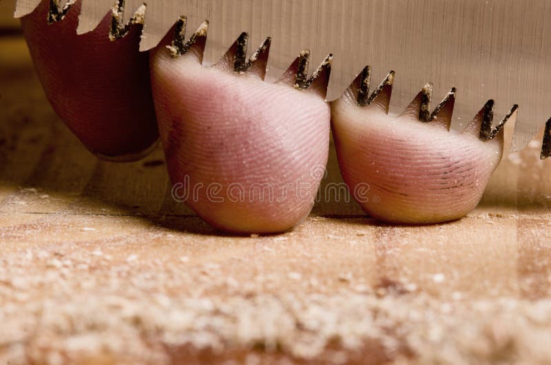 Close-up of Sharp Hand Saw Blade and Fingers of Carpenter or Worker ...