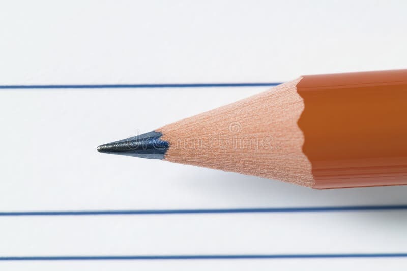 Close-up of a Sharpened Pencil Resting on Lined Paper Ready for Writing ...