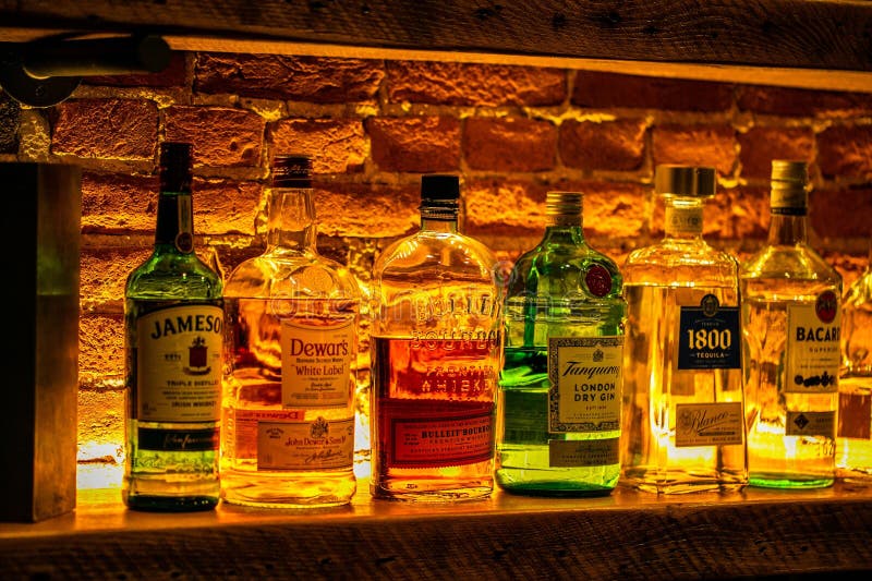 Close-up of a Shelf of Various Types of Alcoholic Beverage Bottles ...
