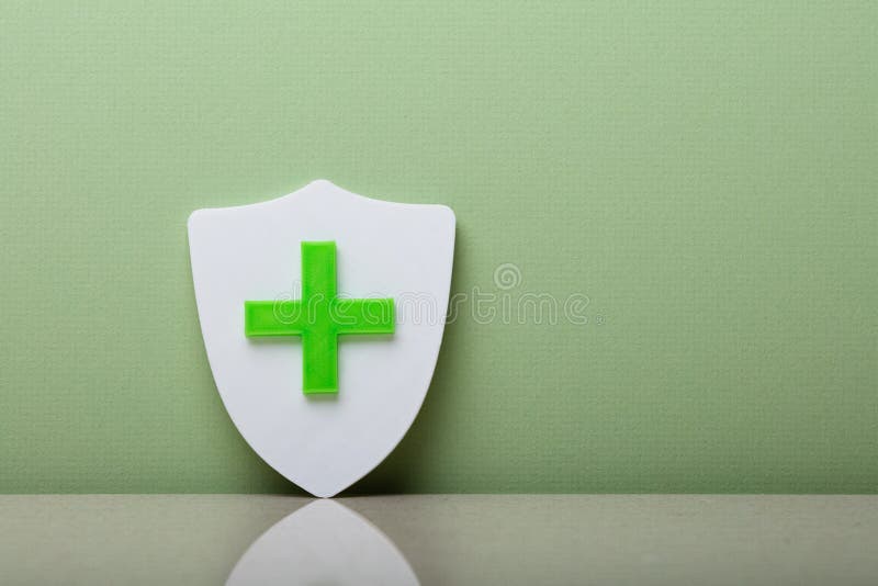 Close-up of a Shield with Plus Sign Stock Image - Image of desk, green ...