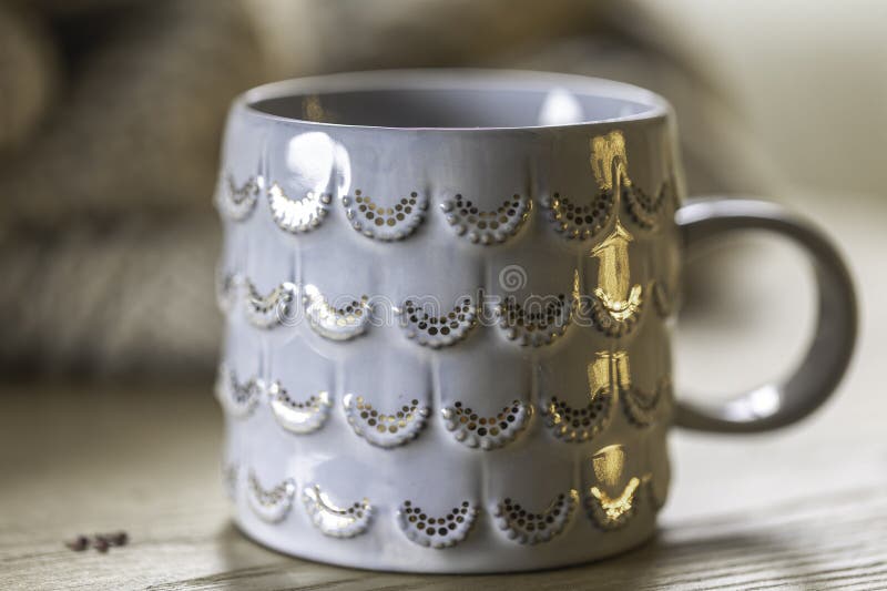Close-up, Shiny Gray Cup on a Blurred Background with a Knitted Element ...