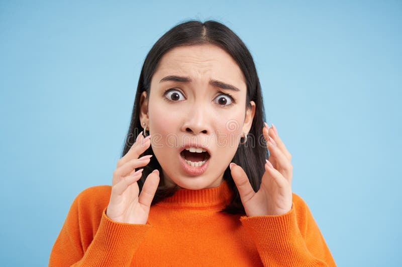 Close Up Of Shocked Asian Woman In Panic Anxious Looks Terrified