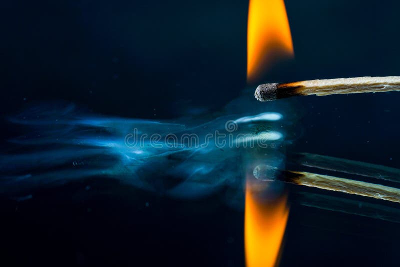 Close Up Shot of a Burning Match on a Blue Background Stock Image ...