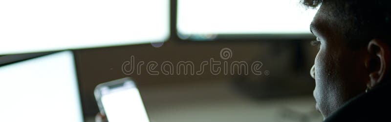 Close Up Shot of Busy Young Guy Sitting in Dark Room in Front of Many ...