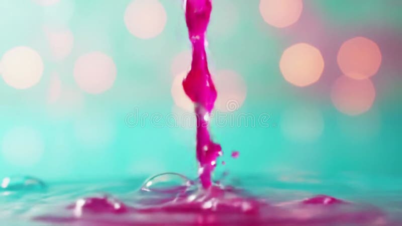 Crimson Liquid Cascading into Water Creating Ripples and Soft Blurred ...