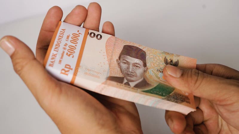 Counting Indonesian Rupiah, Handling 5000 IDR Banknotes Manually Stock ...