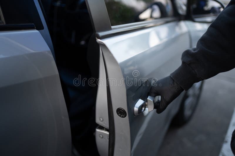Close-up Shot of a Car Thief Hand Pulling the Handle of the Car. Car ...