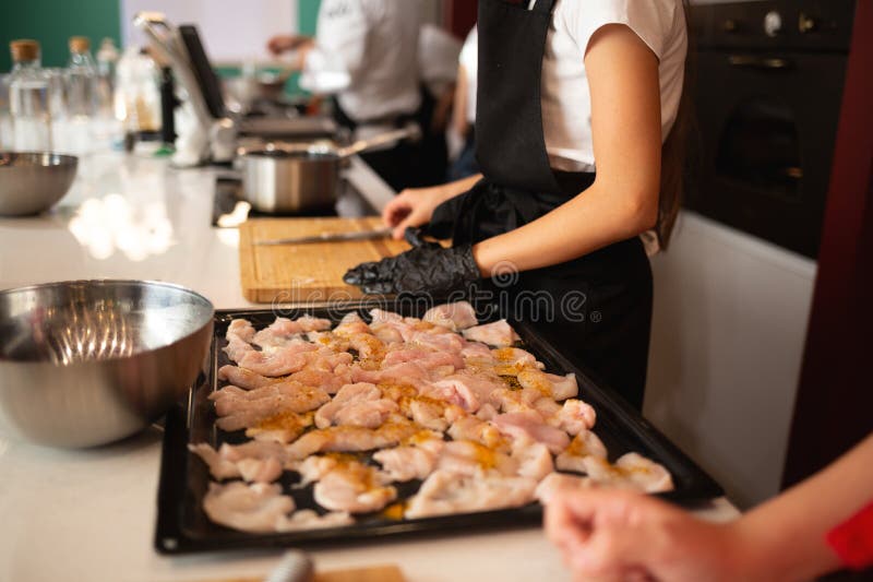 Close-up Shot. Children Stack Fresh Organic Chicken Fillets on a Baking ...