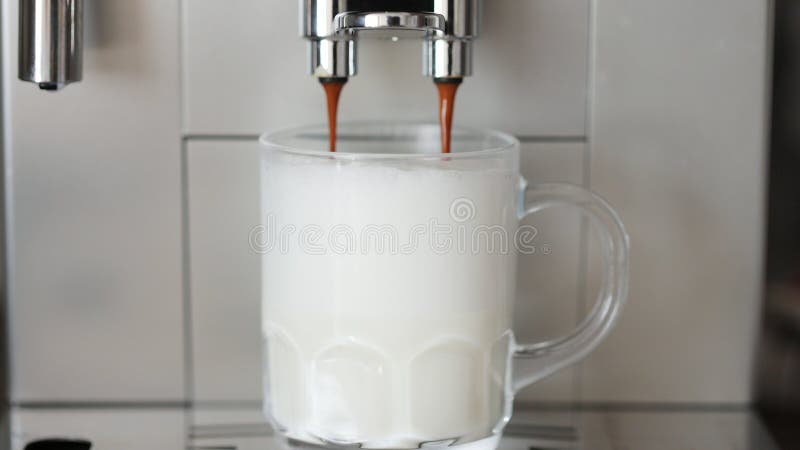 Close Up Shot of Coffee Pouring into Glass Cup with Milk, Making ...