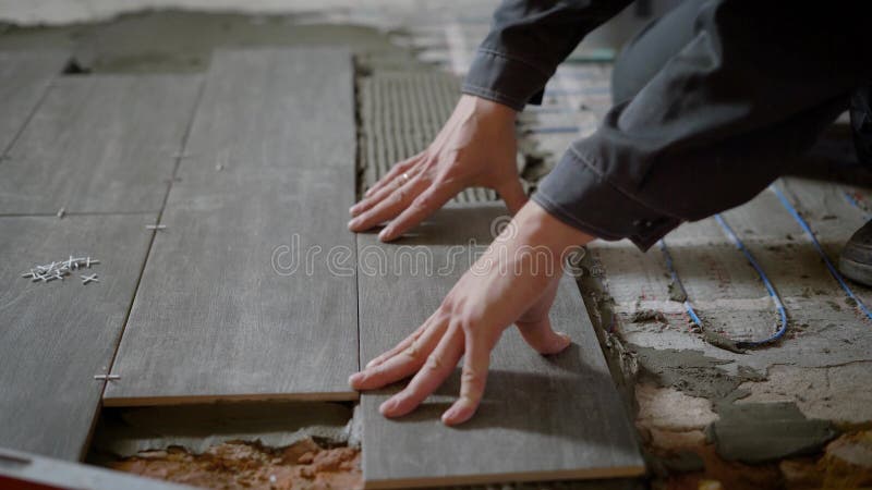 Laying of Ceramic Tiles at the Construction Site Stock Video - Video of ...