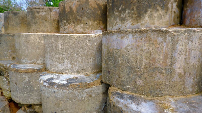 Close-up Shot of Cylindrical Objects of Cement Concrete Stacked Neatly ...