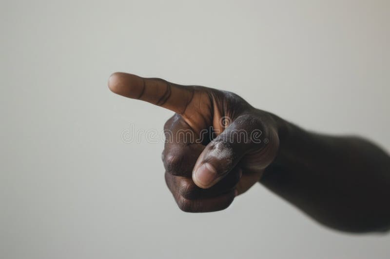 Close-Up of Dark-Skinned Hand Pointing Forward in Minimalist Setting ...
