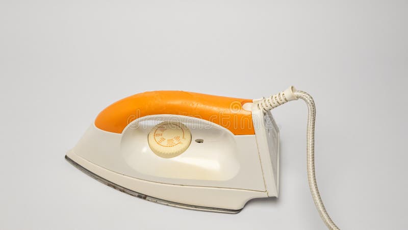 Orange and White Electric Iron on a Light Gray Background Stock Photo ...