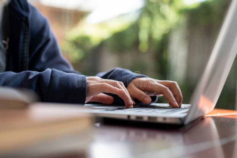 Close-up Shot of a Female Freelancer Working on Her Laptop Computer at ...