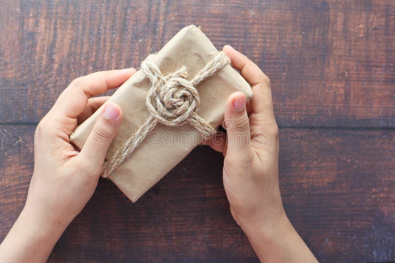 Close Up Shot of Female Hands Holding a Gift Wrapped Stock Photo ...