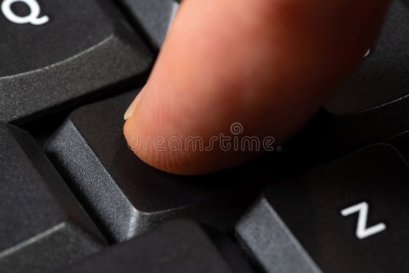 Close-up Shot of a Finger Mid-action As it Presses an Unlabeled Black ...