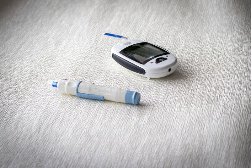 Close Up Shot of the Glucometer Instrument on the White Surface ...