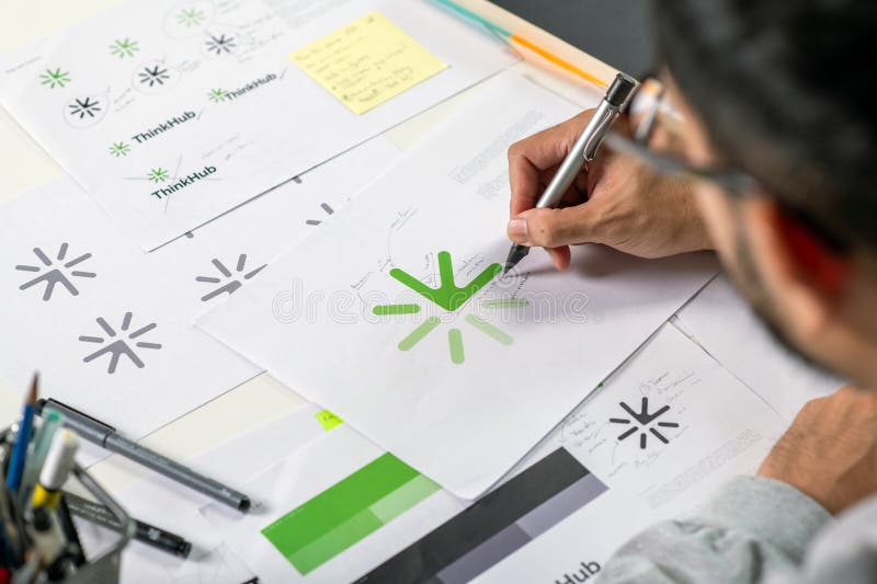 Graphic Designer Making Notes on Logo Designs, Designing Logos, and ...