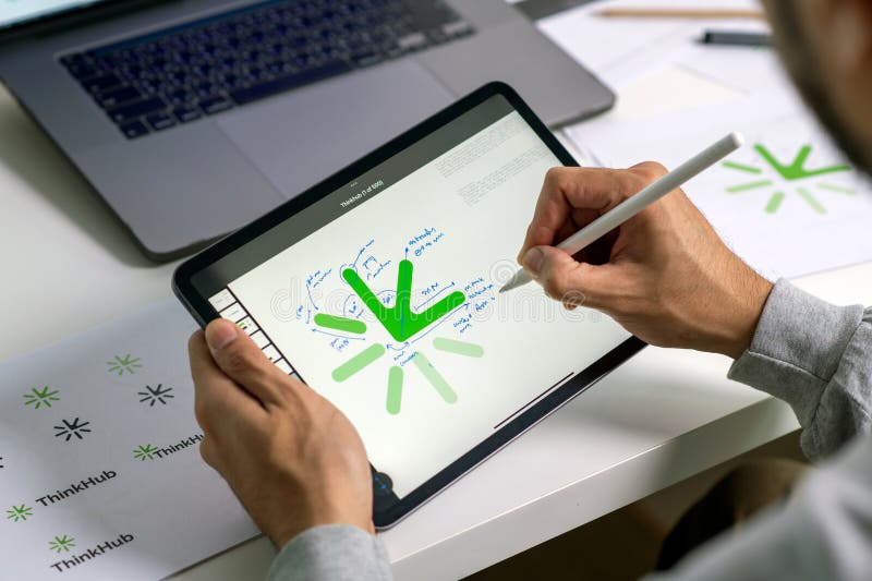 Graphic Designer Making Notes on Logo Designs, Designing Logos, and ...