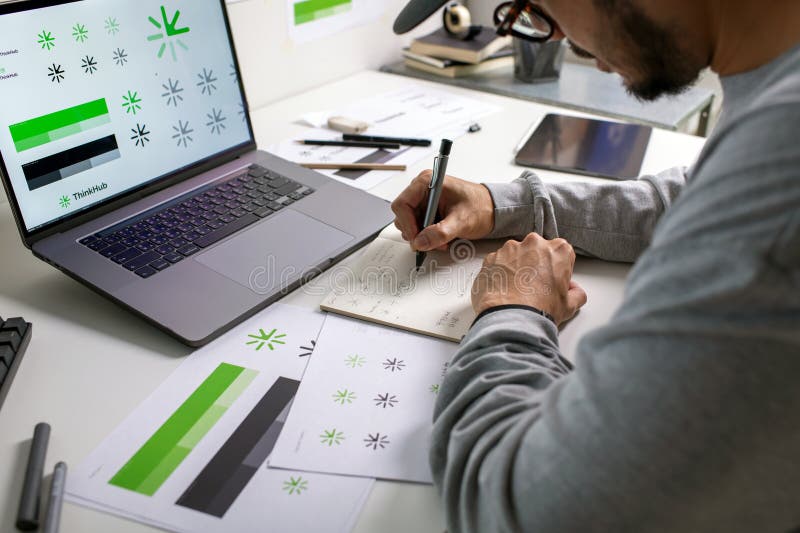 Graphic Designer Making Notes on Logo Designs, Designing Logos, and ...