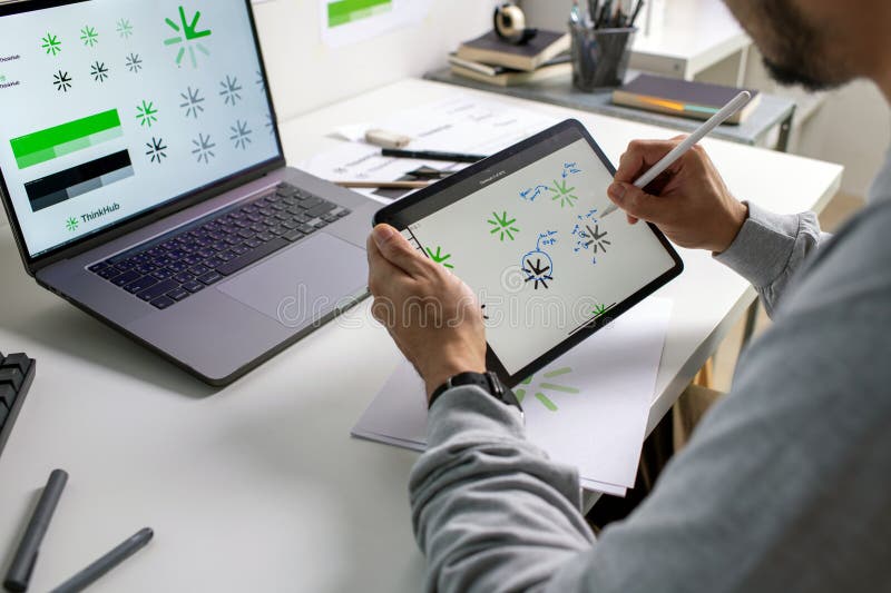 Graphic Designer Making Notes on Logo Designs, Designing Logos, and ...