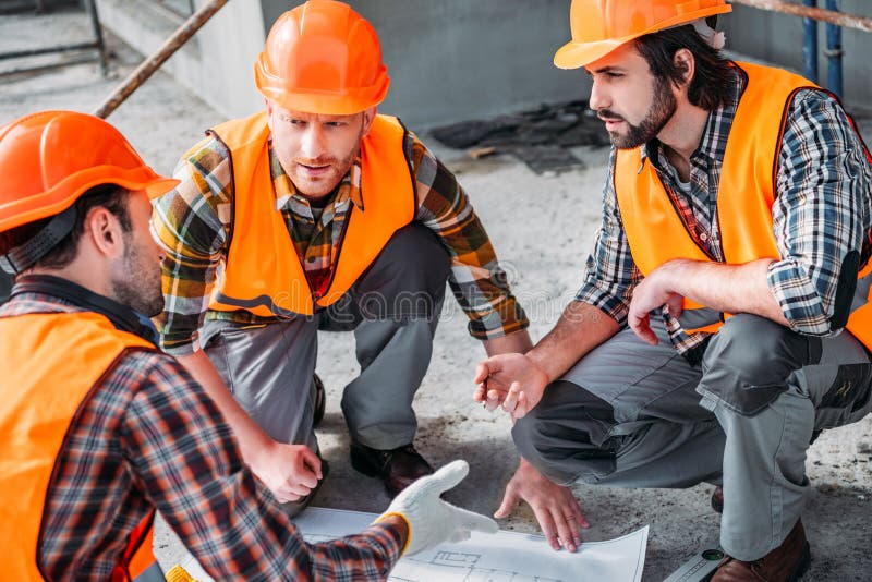 Close-up Shot of Group of Confident Builders Having Conversation about ...