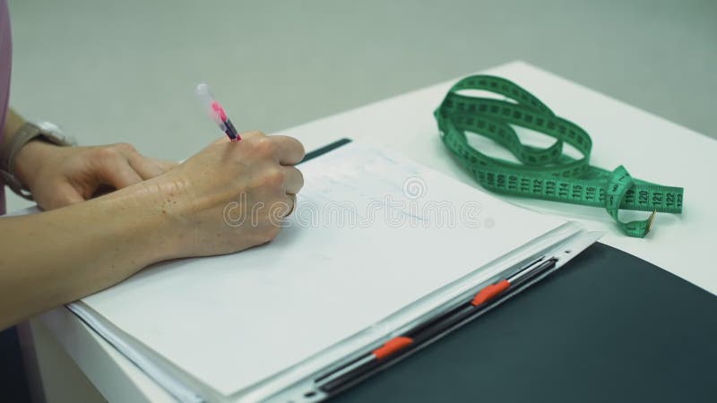 Trainer Making Notes of Measuring Her Client Stock Video - Video of ...