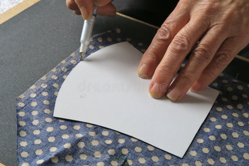 Close-up Shot of Hands of an Old Lady, Pattern, and Fabric when Making ...