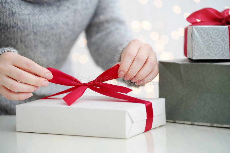 Close Up Shot of Hands Wrapping Xmas Gift at Table. Stock Photo - Image ...