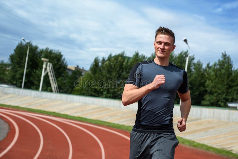 Close Up Shot of Happy Running Man on the Stadium Stock Photo - Image ...