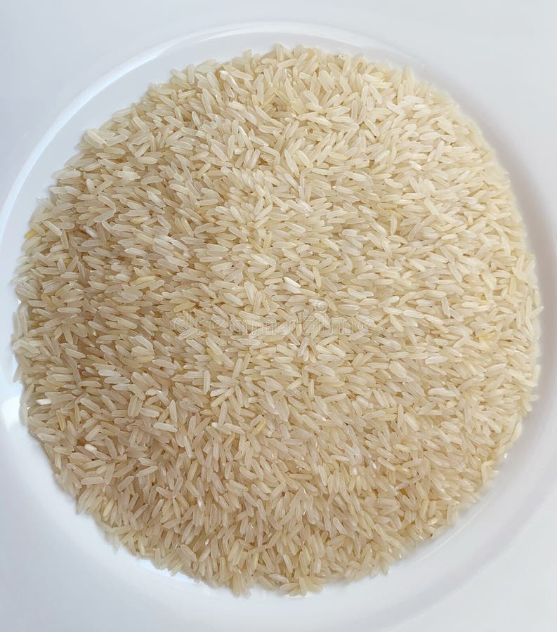 Close Up Shot of a Heap of Uncooked Rice in a White Plate. Stock Photo ...