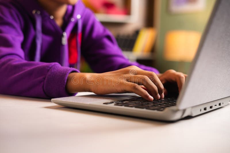Close Up Shot of Indian Kid Hands Using Laptop in Front of Notebook at ...