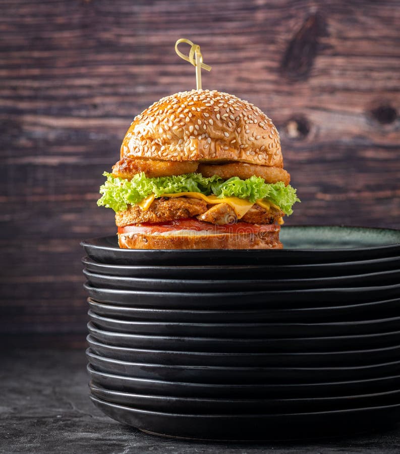 Close-up Shot of a Juicy Burger Placed on a Several Plates Stock Image ...