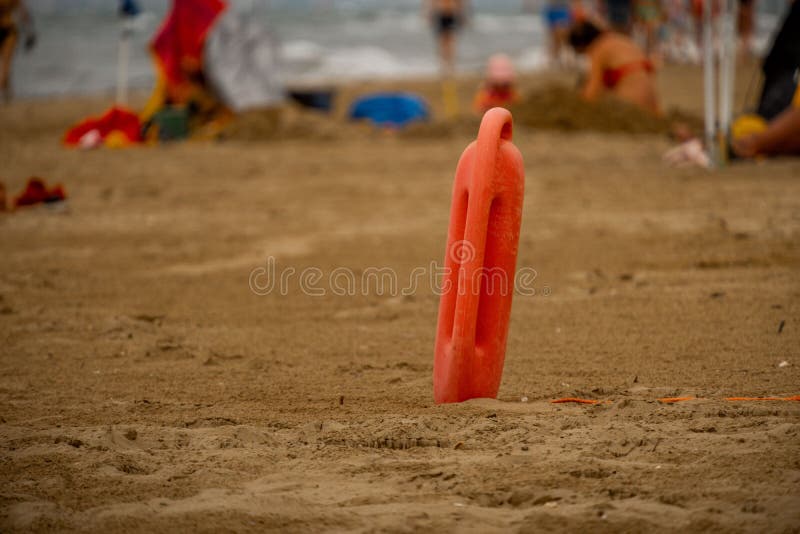 Close-up Shot of a Lifebuoy Stuck in the Sand Stock Image - Image of ...