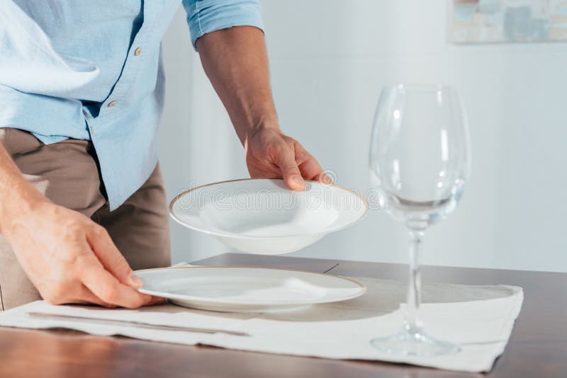 Close-up Shot of Man Serving Table with Plates Stock Image - Image of ...