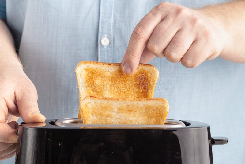 Close-up Shot of Man Taking Toast from Toaster Stock Photo - Image of ...